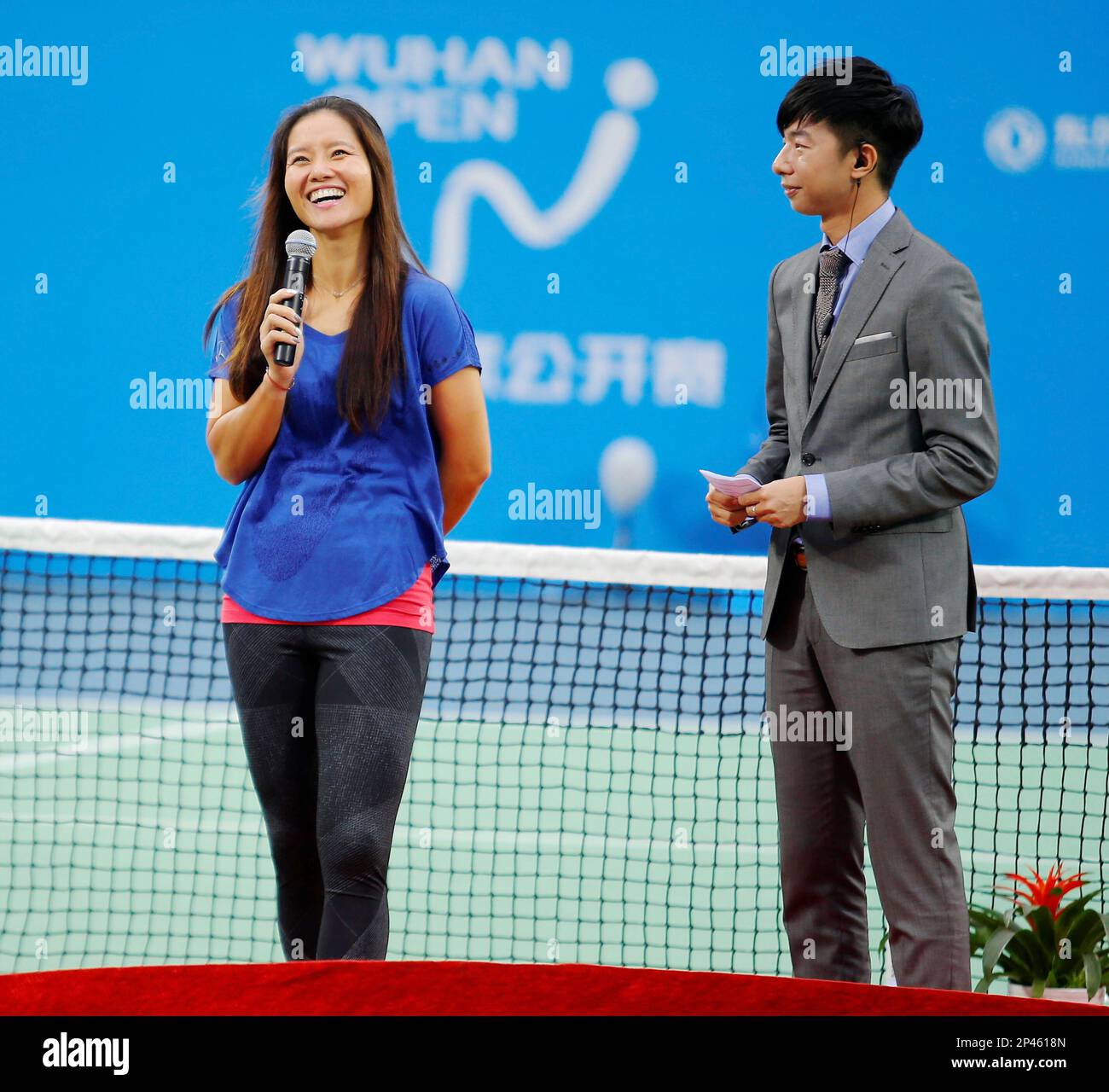 Chinese tennis star Li Na, left, reacts to an interview during a brief ...