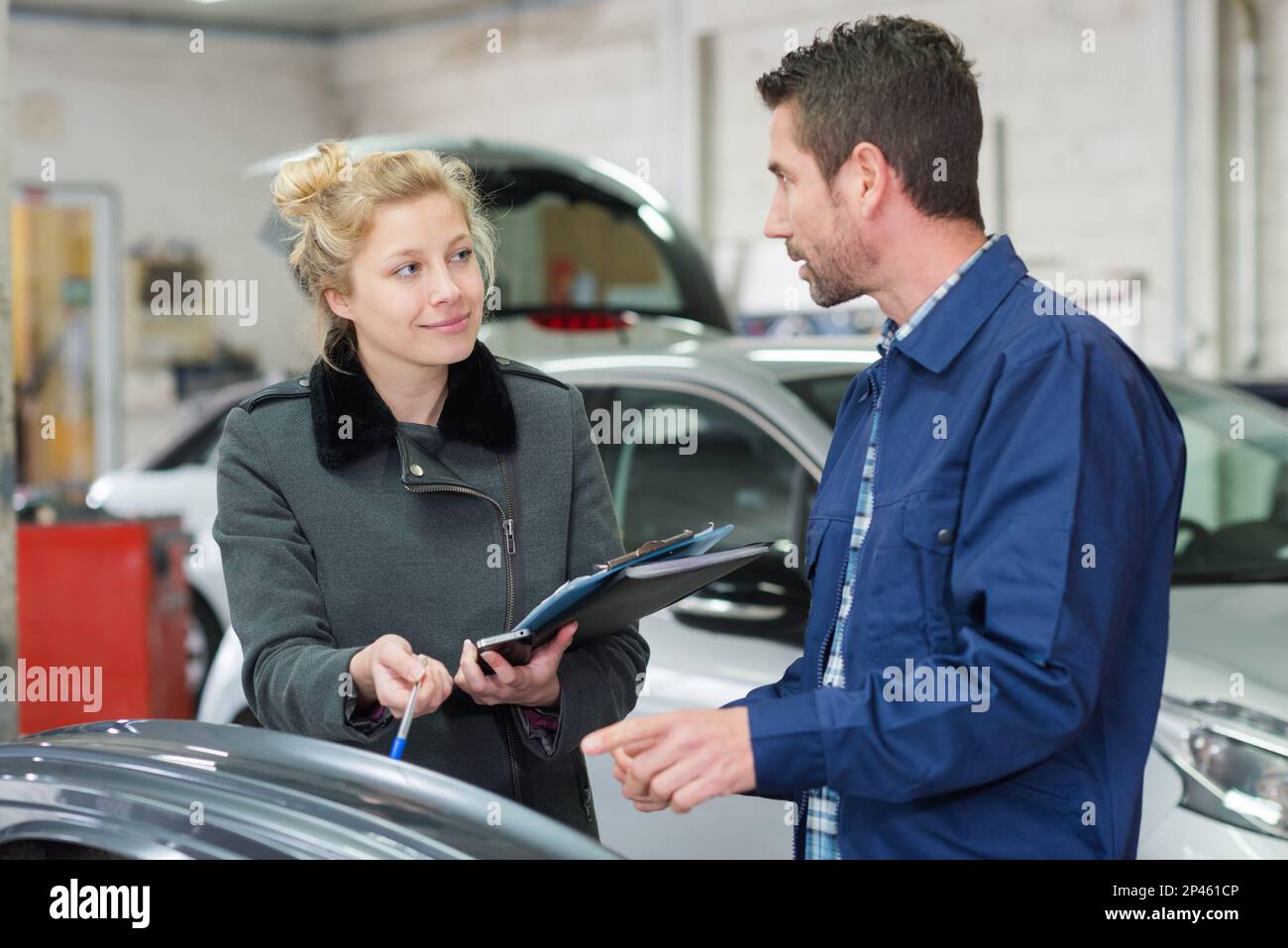 team of mechanics working at the garage Stock Photo - Alamy