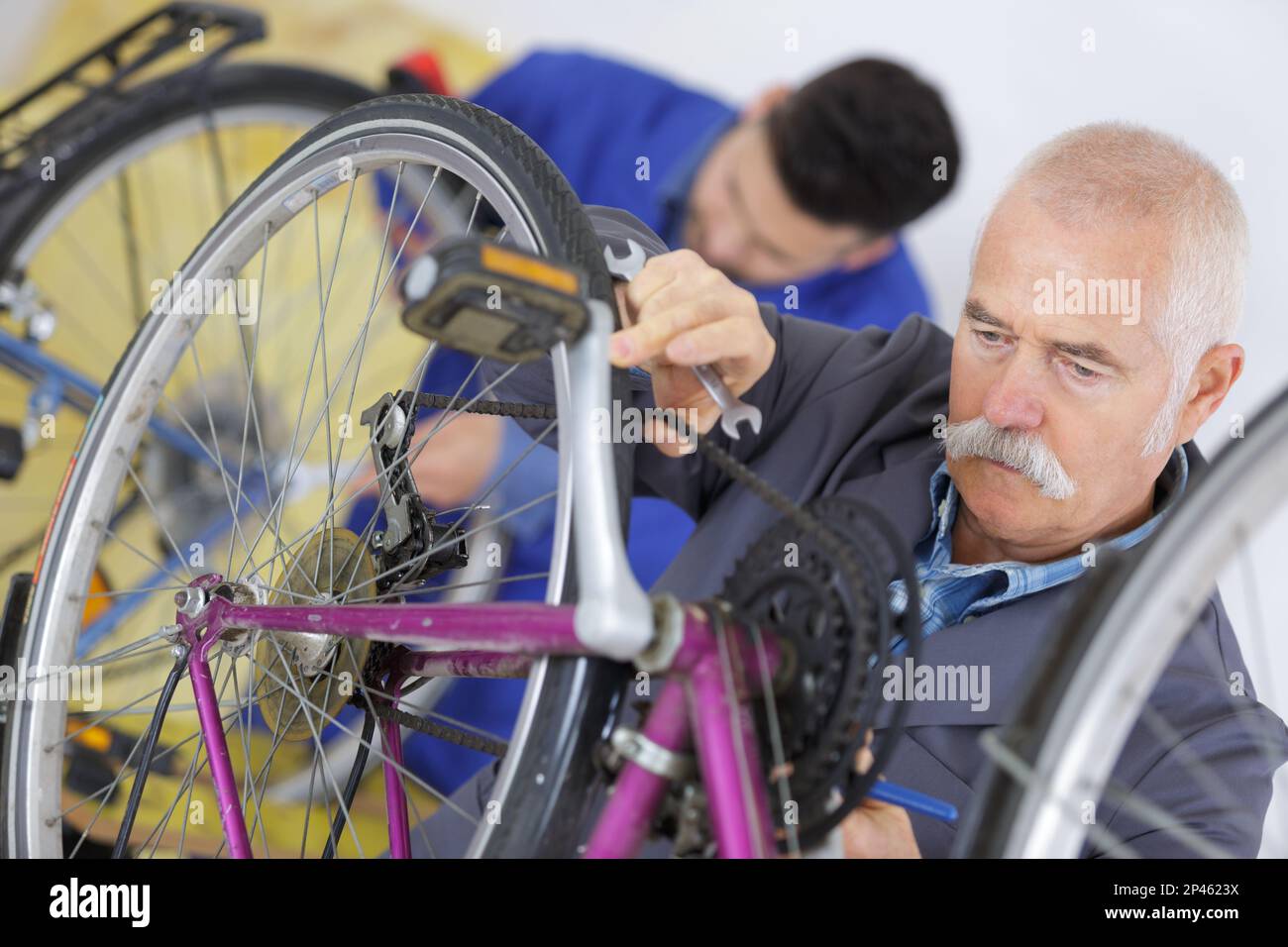 a senior man fixing bike Stock Photo - Alamy