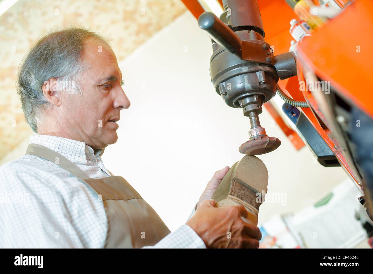 Cobbler shaping heel of shoe Stock Photo - Alamy