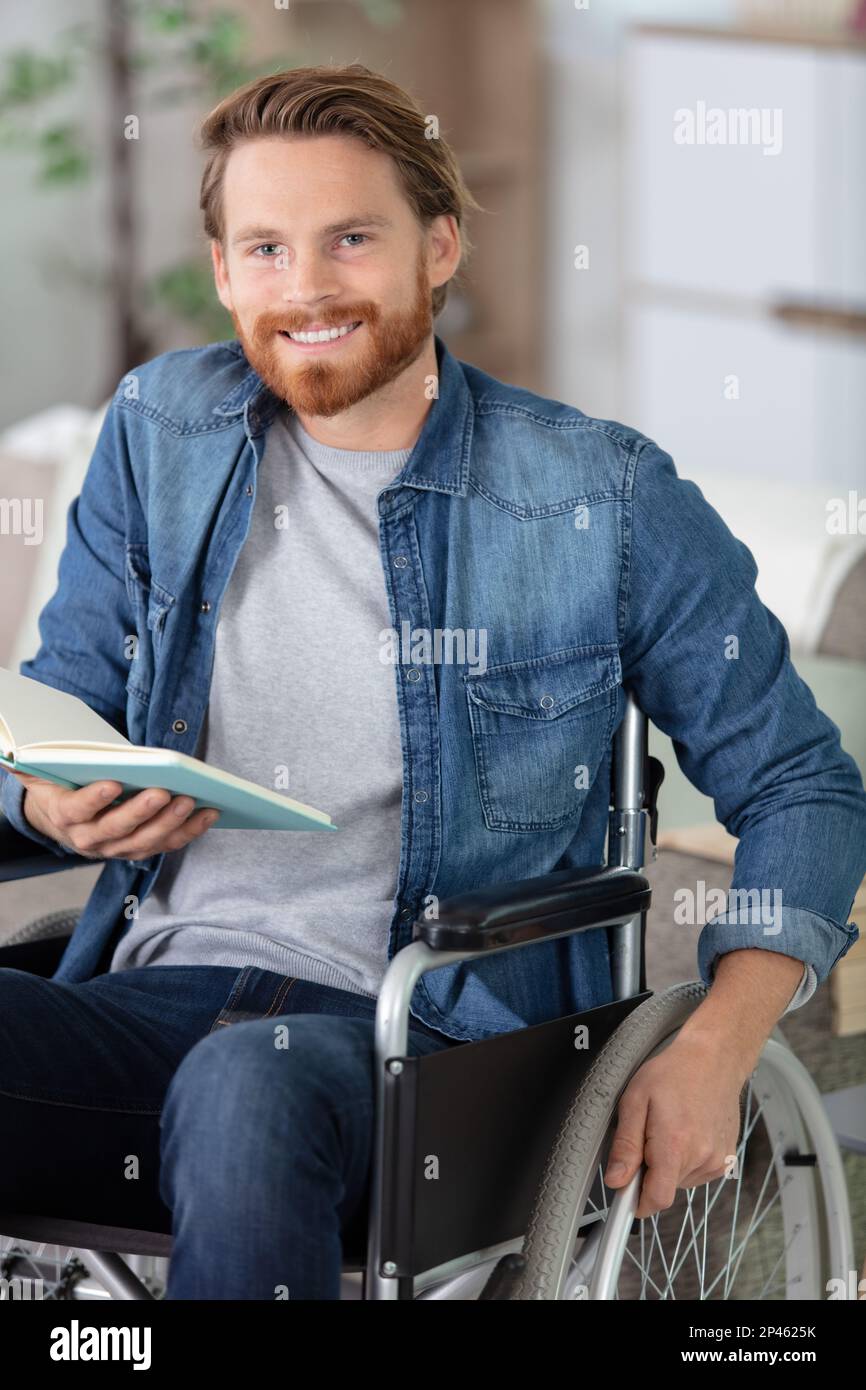 physically handicapped man in wheelchair with a book Stock Photo - Alamy