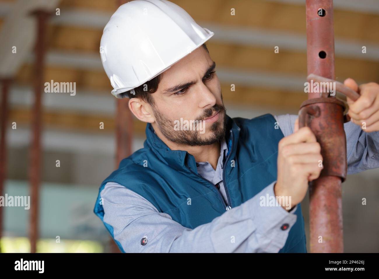 serious builder working with pipes Stock Photo - Alamy