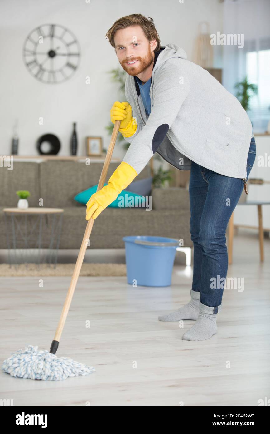 young man mopping floor Stock Photo - Alamy