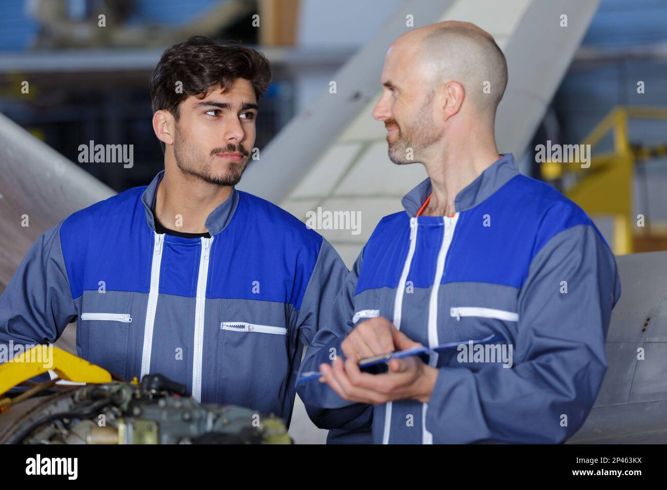 portrait of modern aircraft engineers in hangar Stock Photo - Alamy