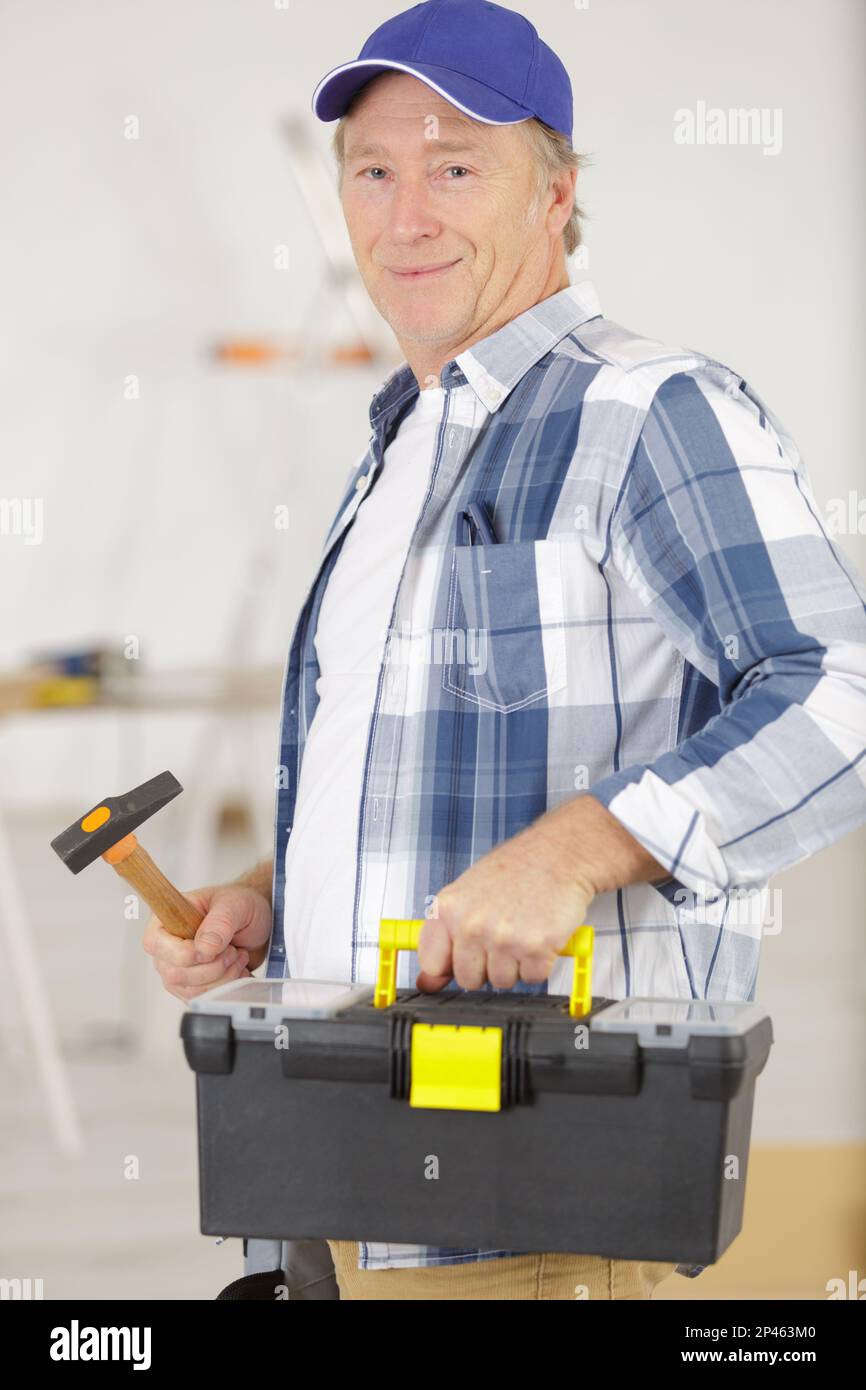 mature man carrying a toolbox Stock Photo - Alamy