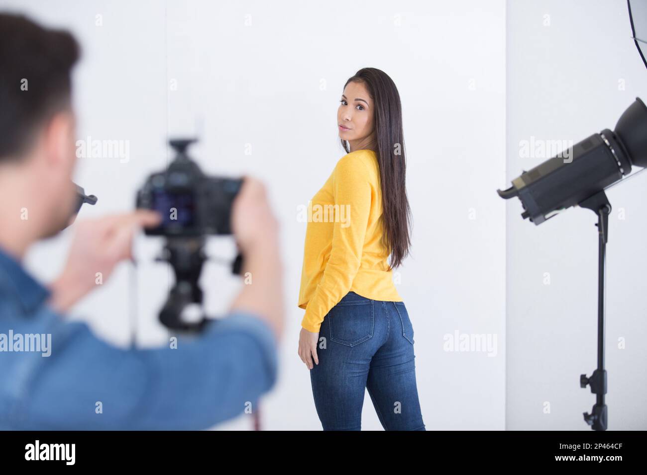 professional photographer reviewing picture and model in studio Stock ...