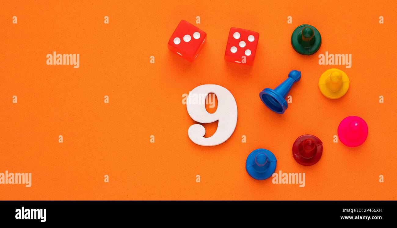 Number 9 with dice and board game pieces - Orange eva rubber background ...