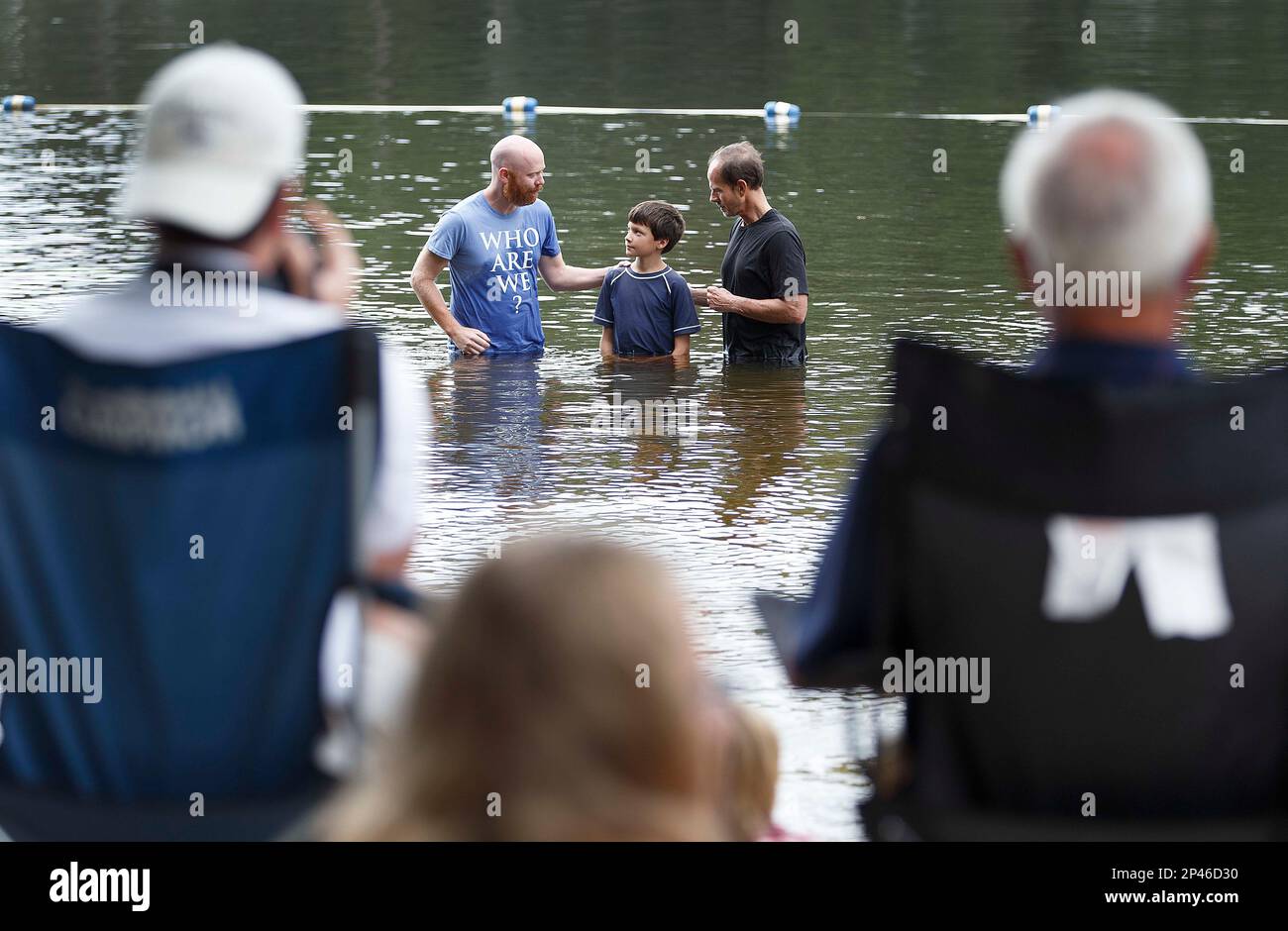 In this Sunday, Aug. 24, 2014 photo, in background, pastors Marshall ...