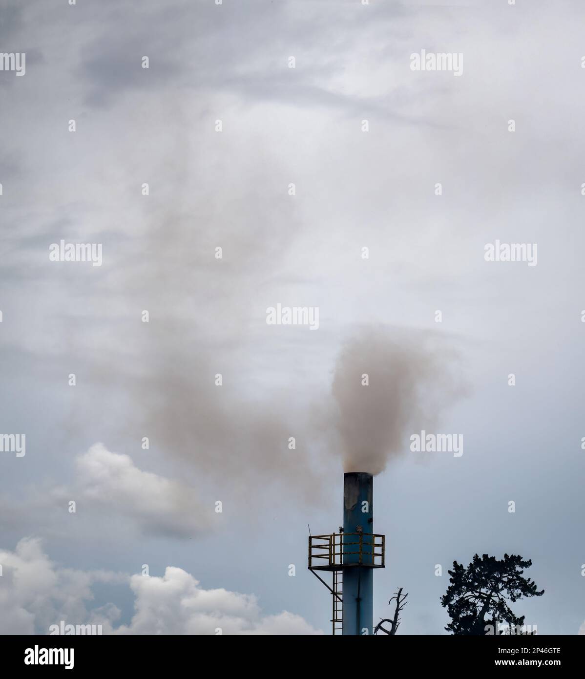 Heavy smoke from a chimney against a polluted sky. New Zealand ...