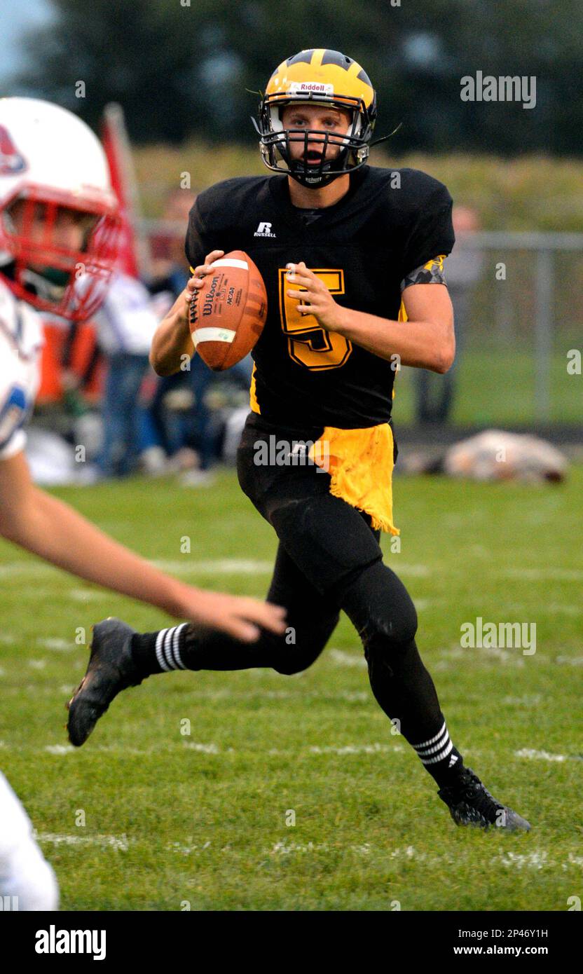 Pioneer High School quarterback Sam Kiser rolls out and looks down ...