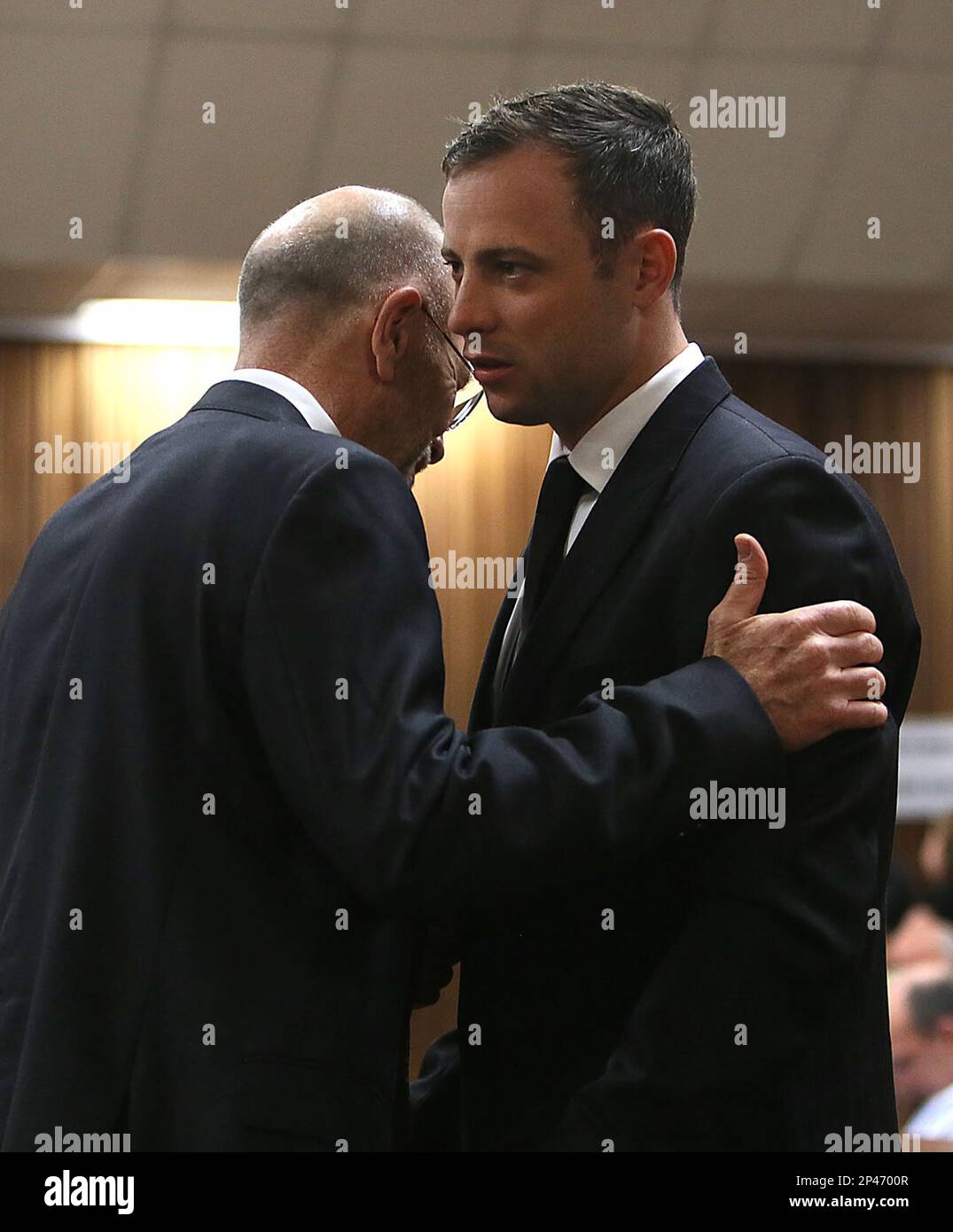 Oscar Pistorius, right, is comforted by his uncle Arnold Pistorius, in ...