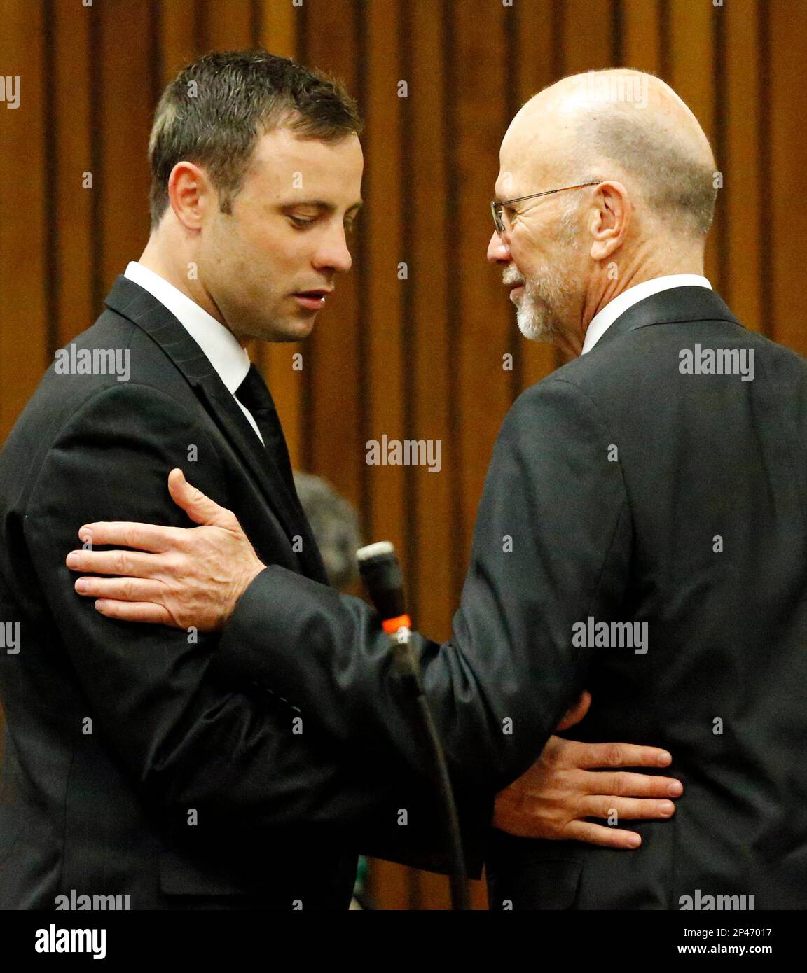 Oscar Pistorius, left, stands with his uncle Arnold Pistorius in court ...