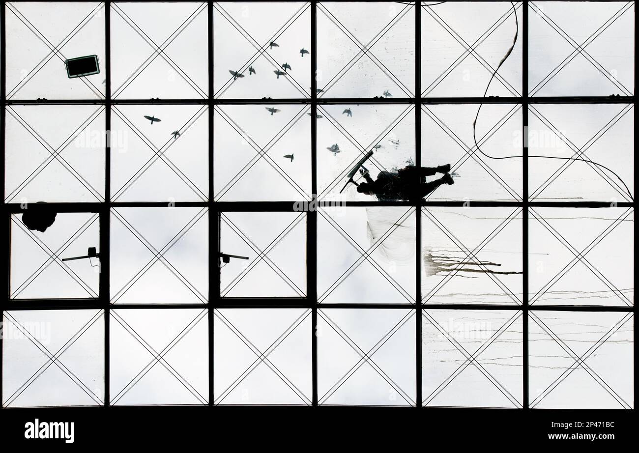 Facade and window cleaner Michael Lehmann cleans the glass roof of an ...