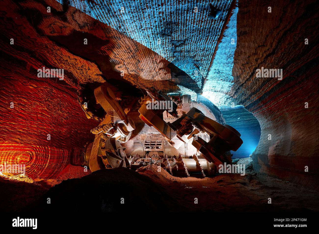 Illuminated mining drilling machine in salt quarry tunnel Stock Photo ...