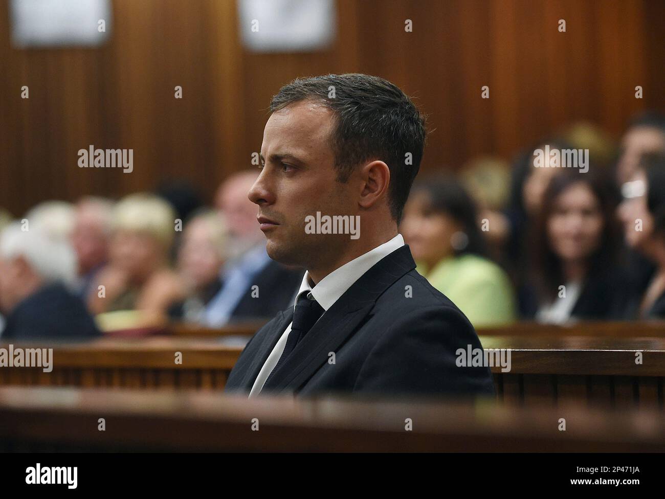 Oscar Pistorius takes his seat in the dock in court in Pretoria, South ...