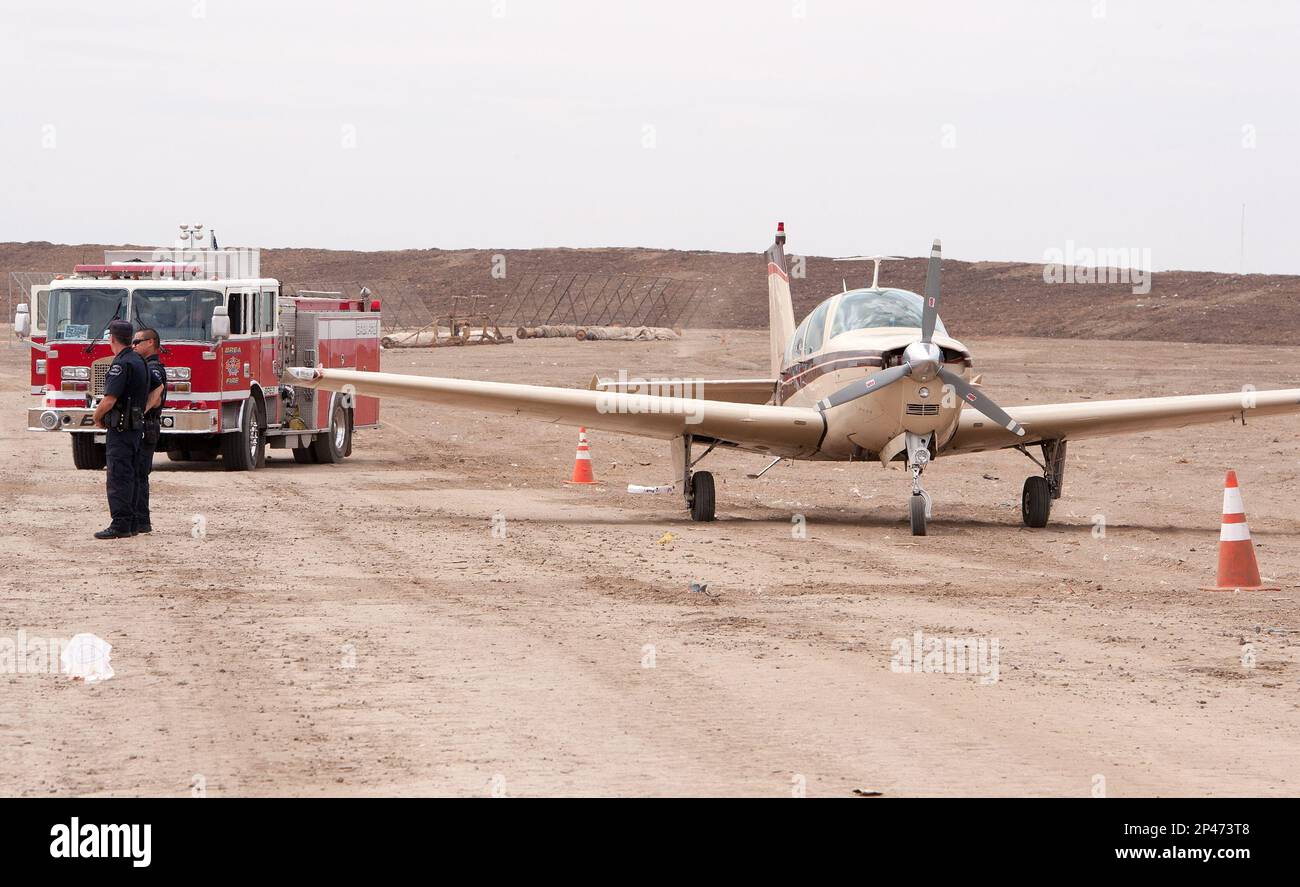 Brea police officers watch over a Beechcraft Bonanza single engine ...