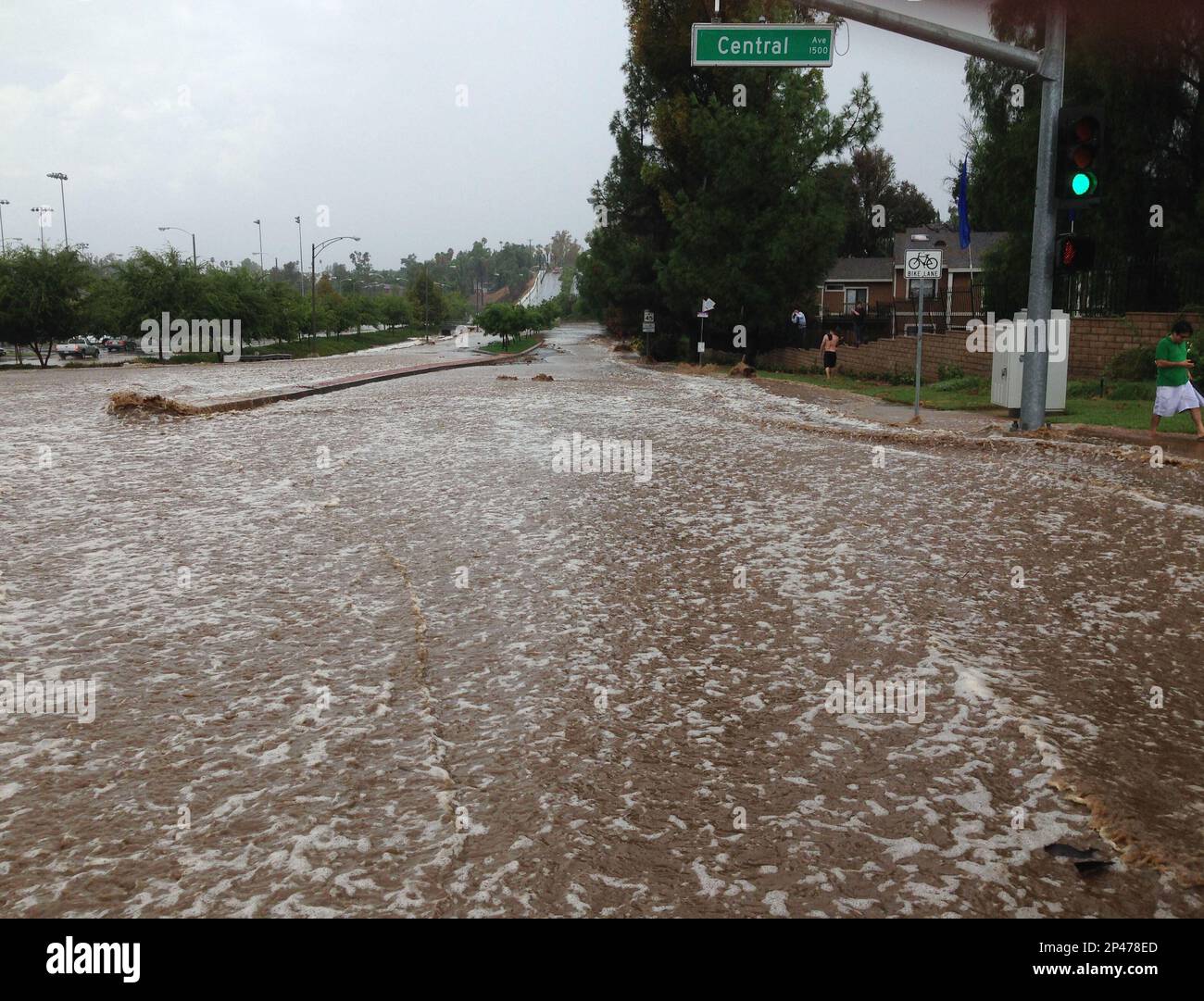 Storm water flows down Chicago Avenue in Riverside, Calif., on Sunday ...