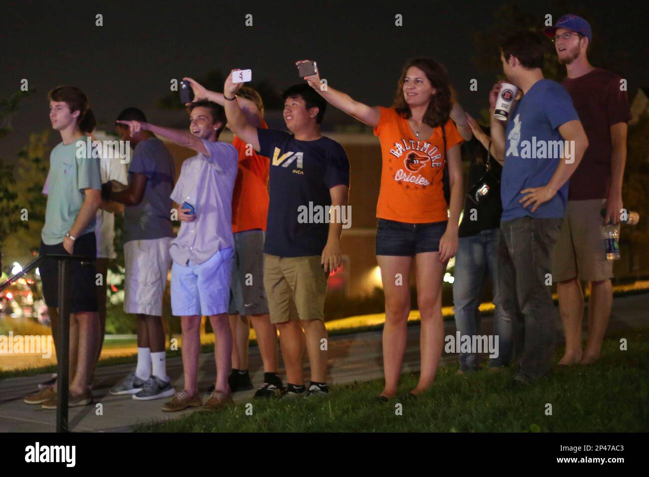 Onlookers watch as hundreds of Virginia Tech football fans celebrate in ...