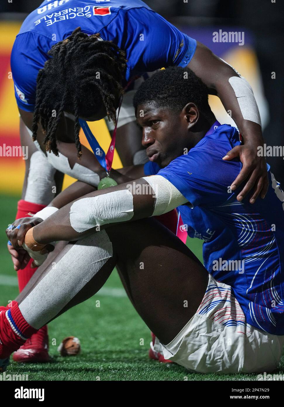 France's Andy Timo, bottom is consoled by teammate William Iraguha ...