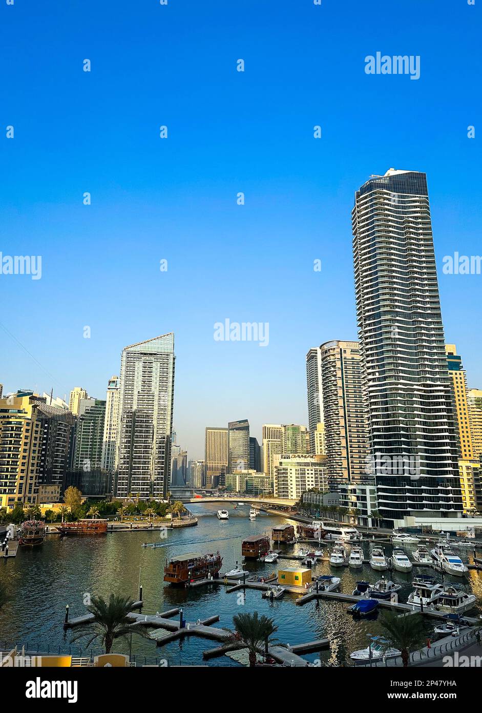 Dubai Marina, harbour, cruise boat and canal promenade view at sunset ...