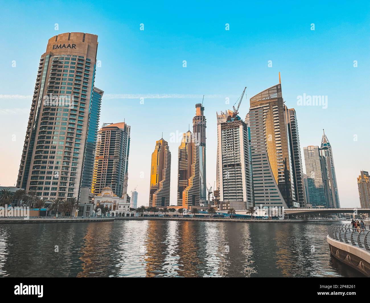 Dubai Marina, harbour, cruise boat and canal promenade view at sunset ...