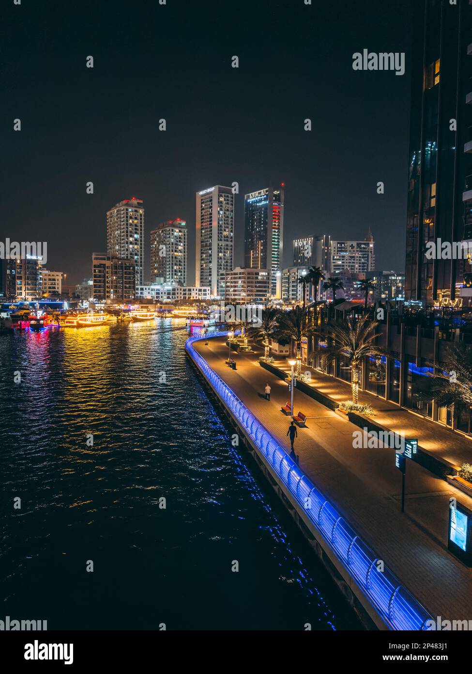 Dubai Marina, harbour, cruise boat and canal promenade view at night ...