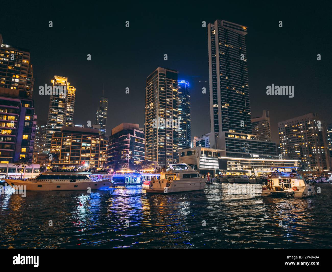 Dubai Marina, harbour, cruise boat and canal promenade view at night ...