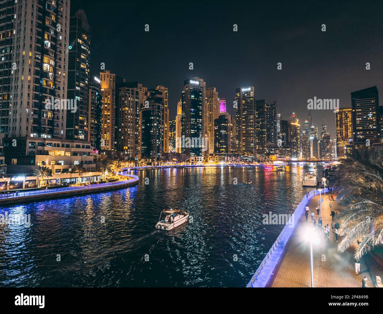 Dubai Marina, harbour, cruise boat and canal promenade view at night ...