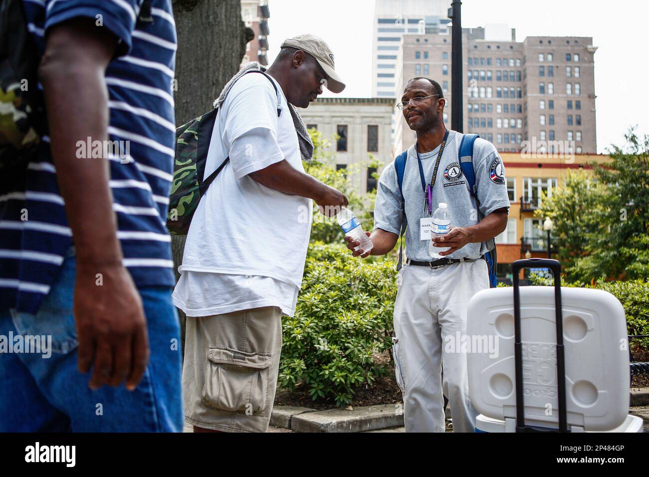Jim Brown III, 48, right, of Memphis, hands out bottles of water to ...