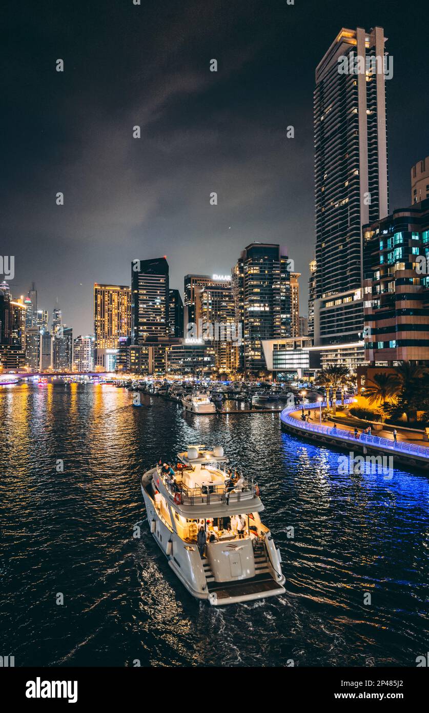 Dubai Marina, harbour, cruise boat and canal promenade view at night ...