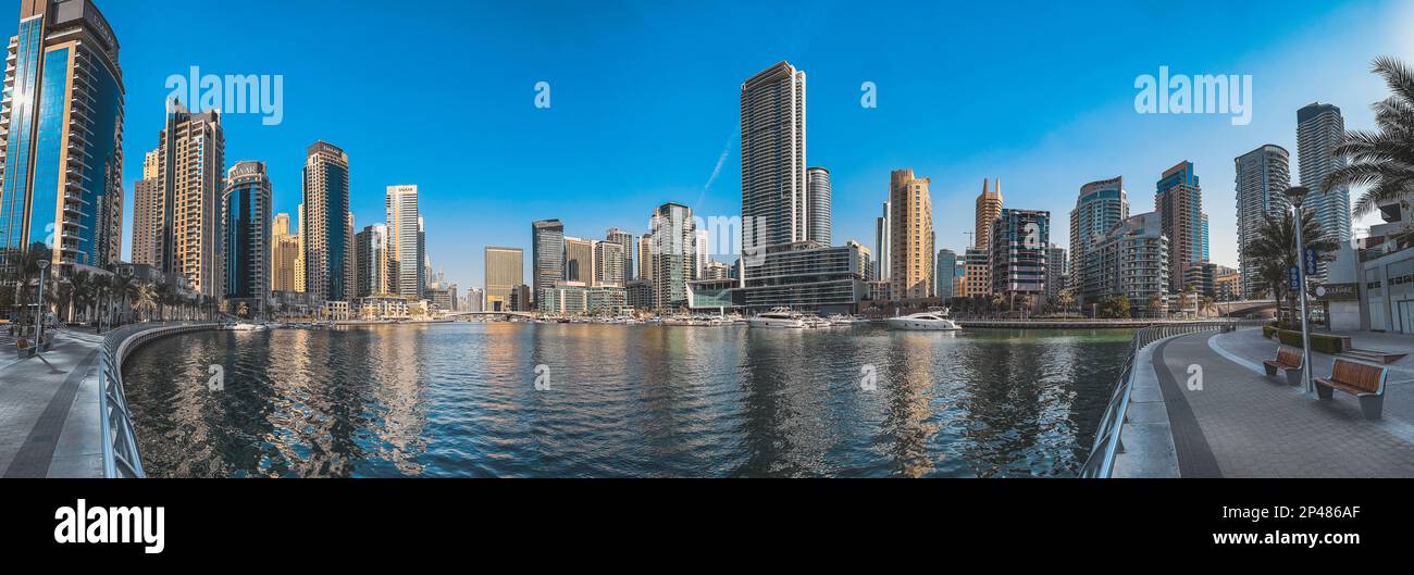 Dubai Marina, harbour, cruise boat and canal promenade view at sunset ...