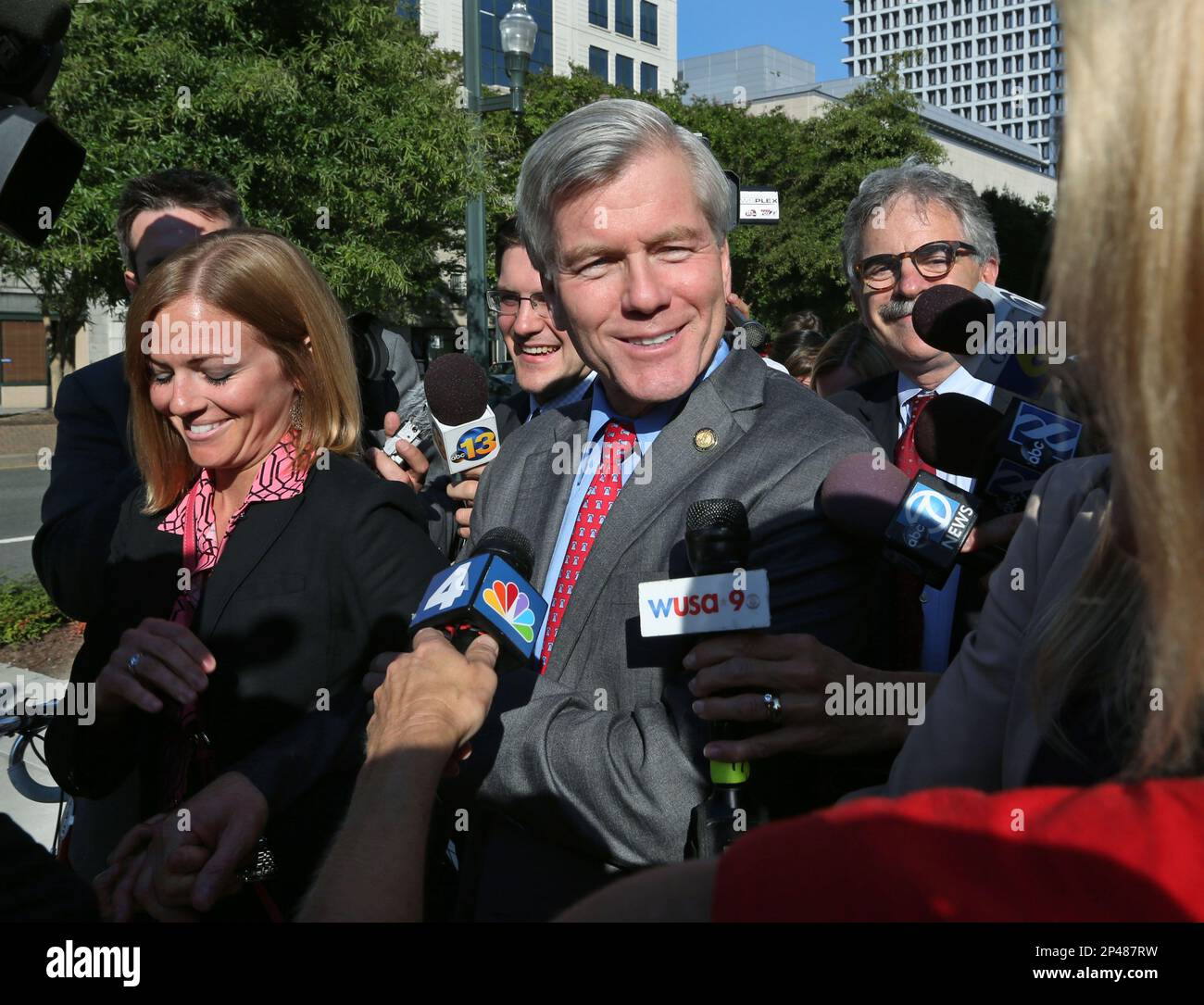 Former Virginia Gov. Bob McDonnell, center, answers reporters ...
