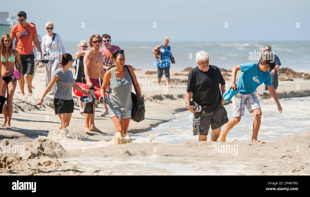 Beachgoers are evacuated as surf overwhelms the beach as huge swells ...