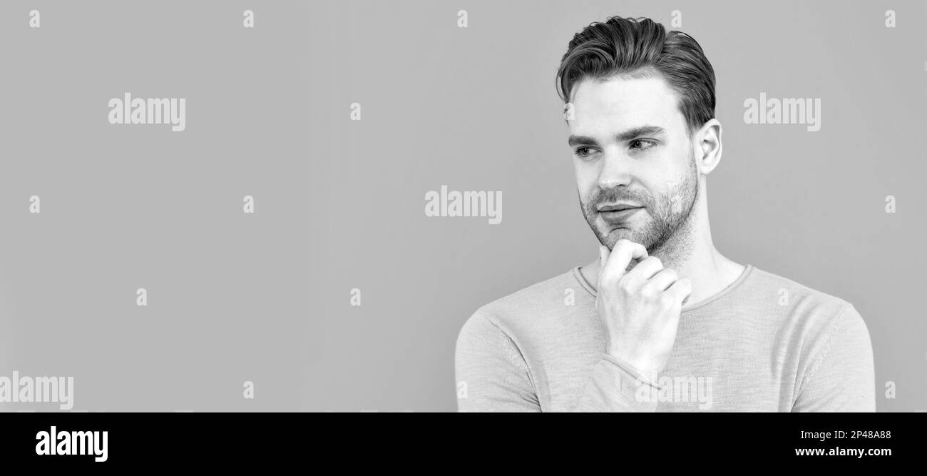 Handsome man with unshaven face portrait grey background, serious. Man ...
