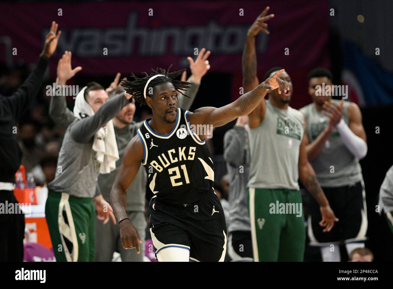Milwaukee Bucks guard Jrue Holiday (21) points after he made a 3 ...