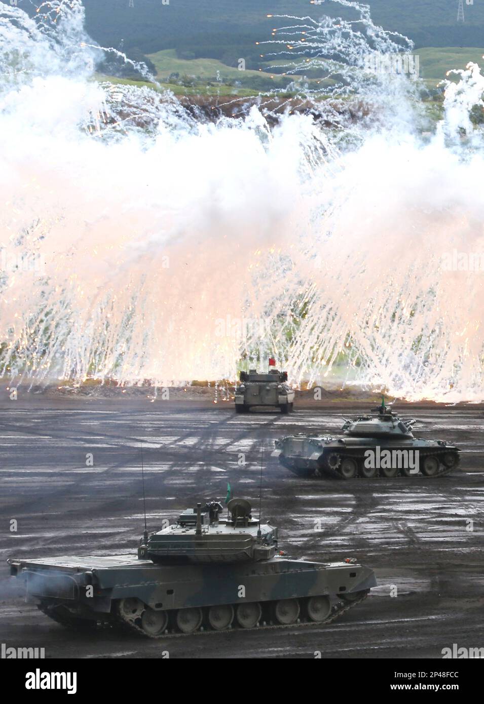 Members of Japan’s Ground Self Defence Force deploy a live-firing drill ...
