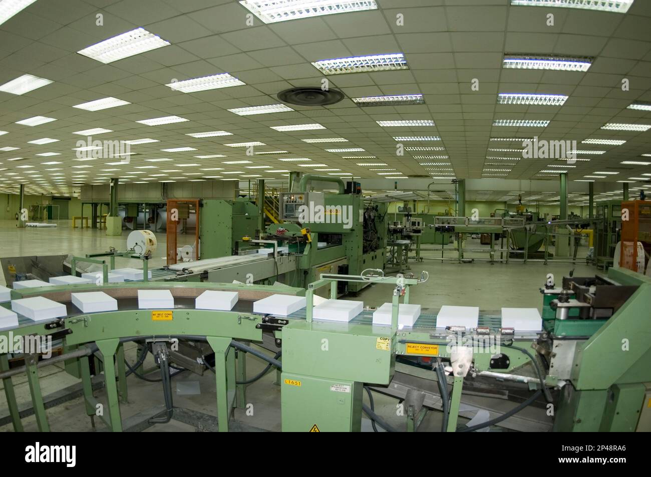 Paper on conveyor belt; Riau Pulp and Paper Mill (RAPP), near Pekanbaru ...