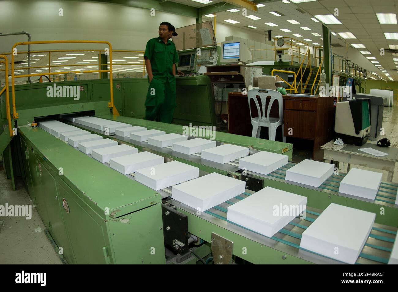 Paper on conveyor belt; Riau Pulp and Paper Mill (RAPP), near Pekanbaru ...