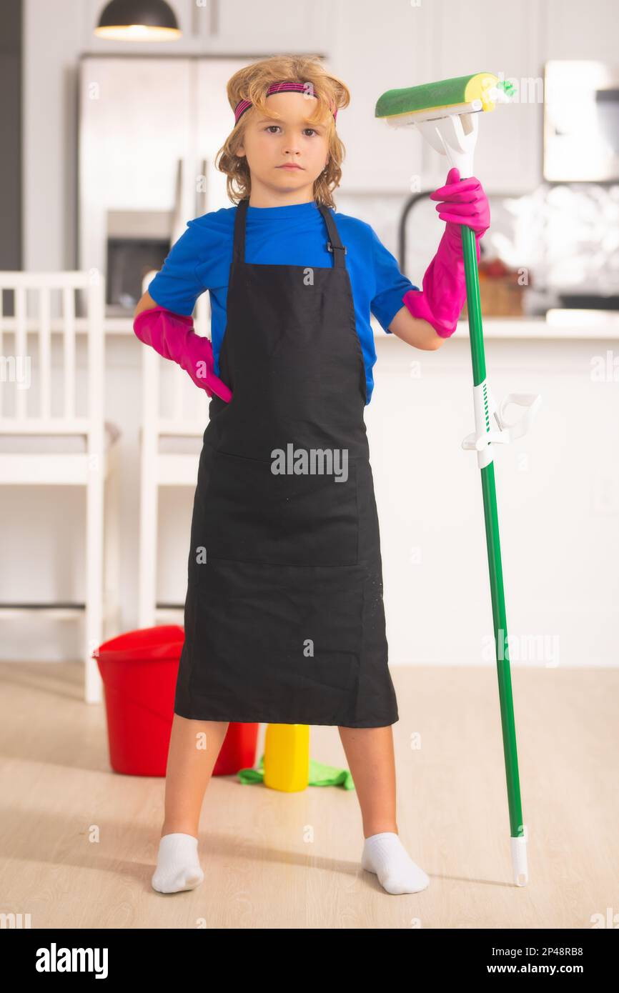 Child cleans at home concept. Kid cleaning with mop to help with ...