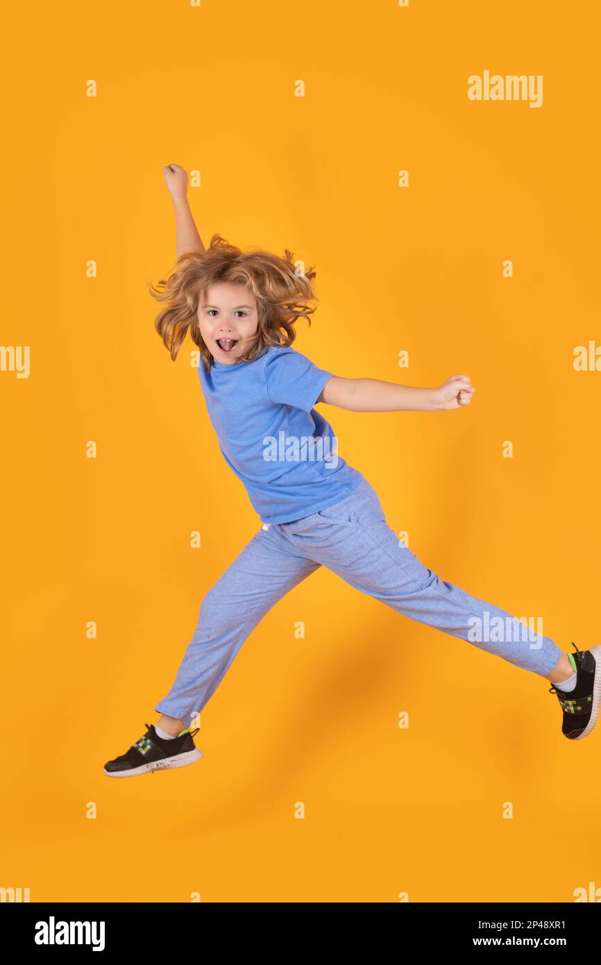 Funny boy jumping. Little child jumping over a yellow background Stock ...