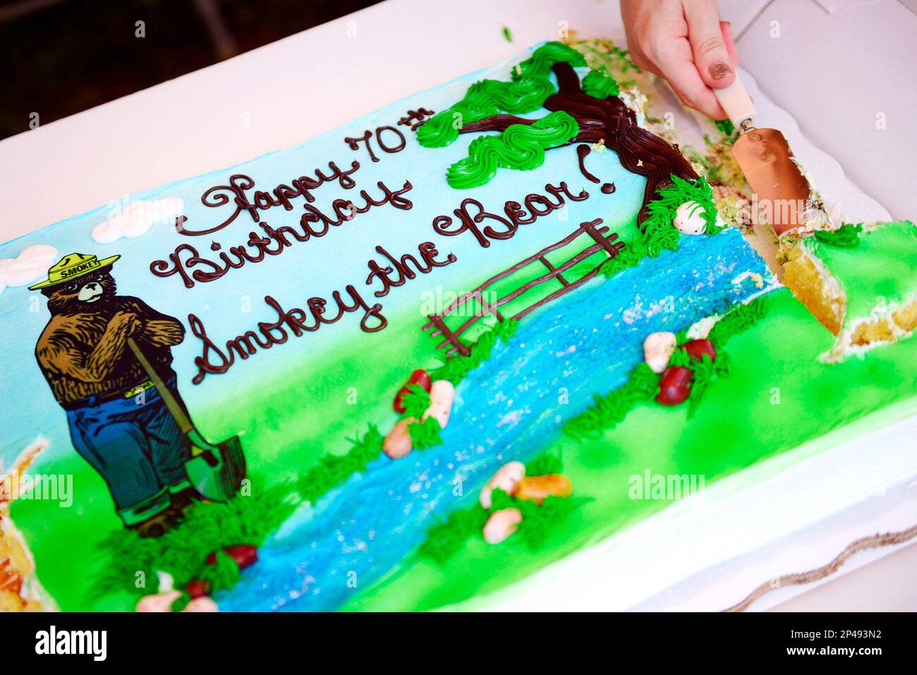 A cake is cut by Heather Ferrand a mitigation specialist with the ...