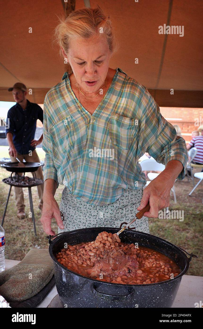 Becky Johnson of the Johnson Ranches stirs a pot of beans during the ...