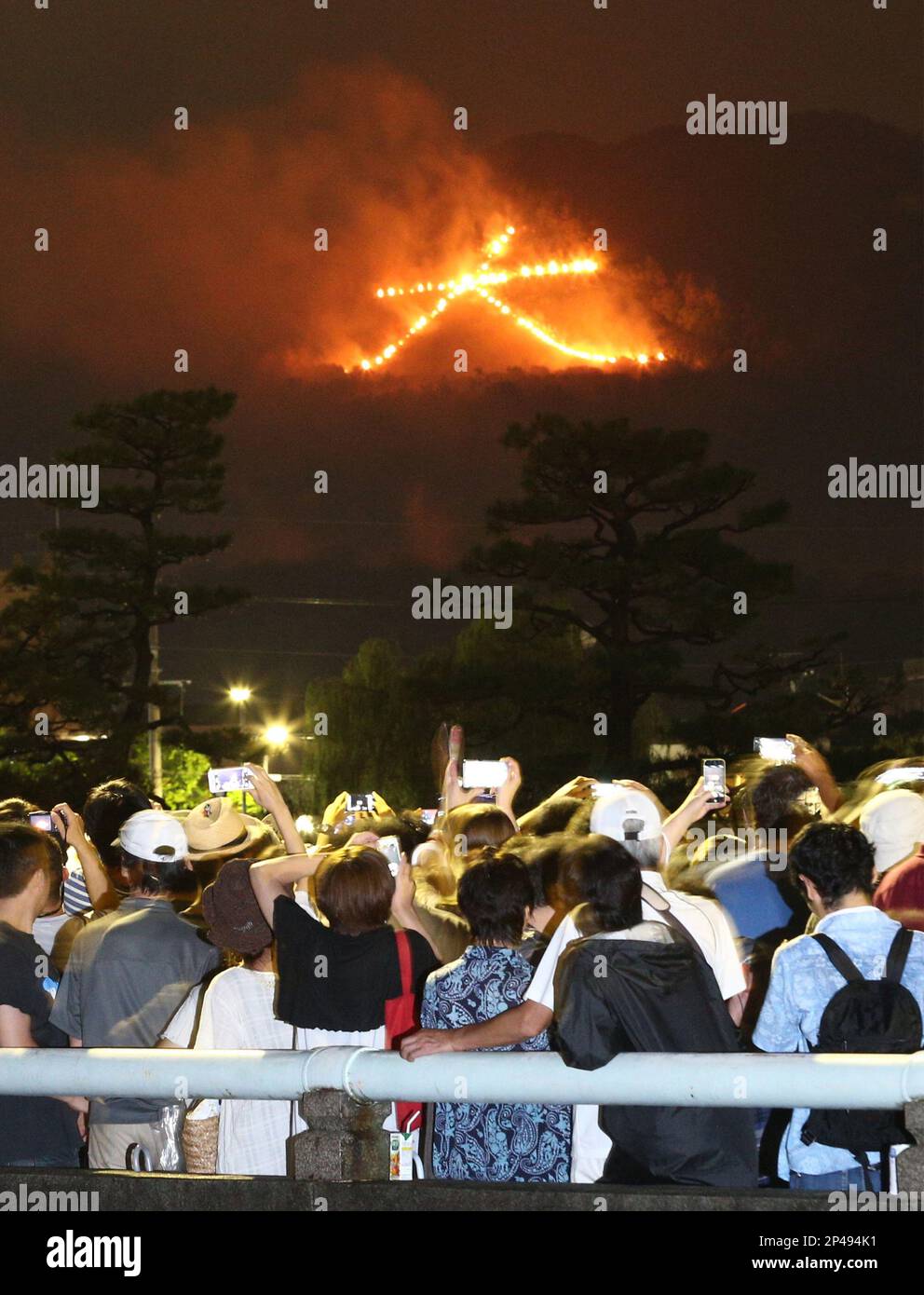 Tourists enjoy Chinese gigantic character "dai," meaning " big ...