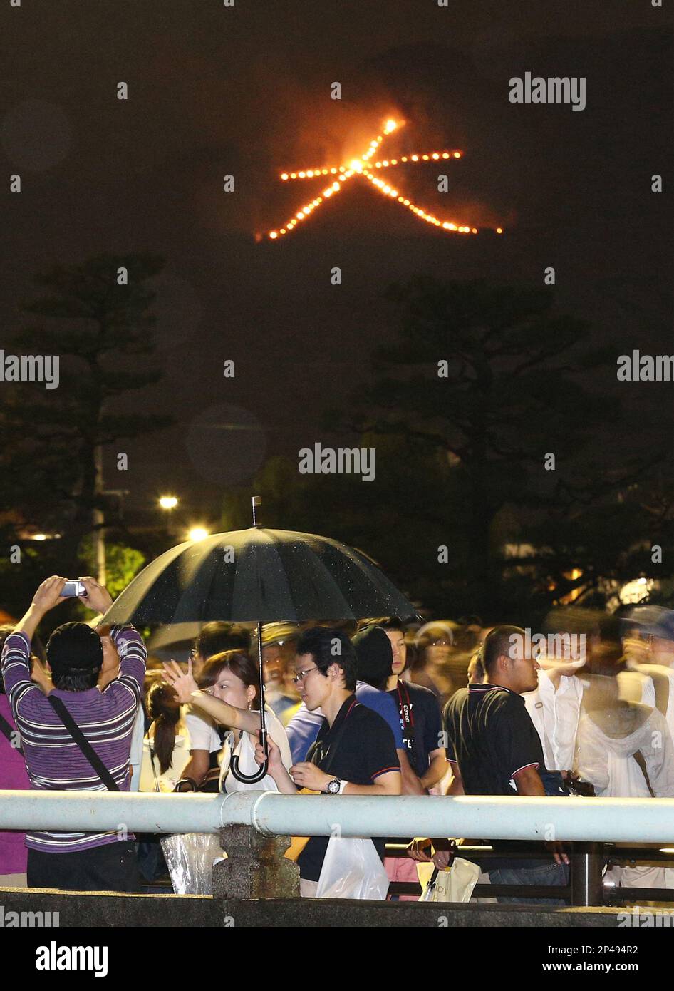 Tourists enjoy Chinese gigantic character "dai," meaning " big ...