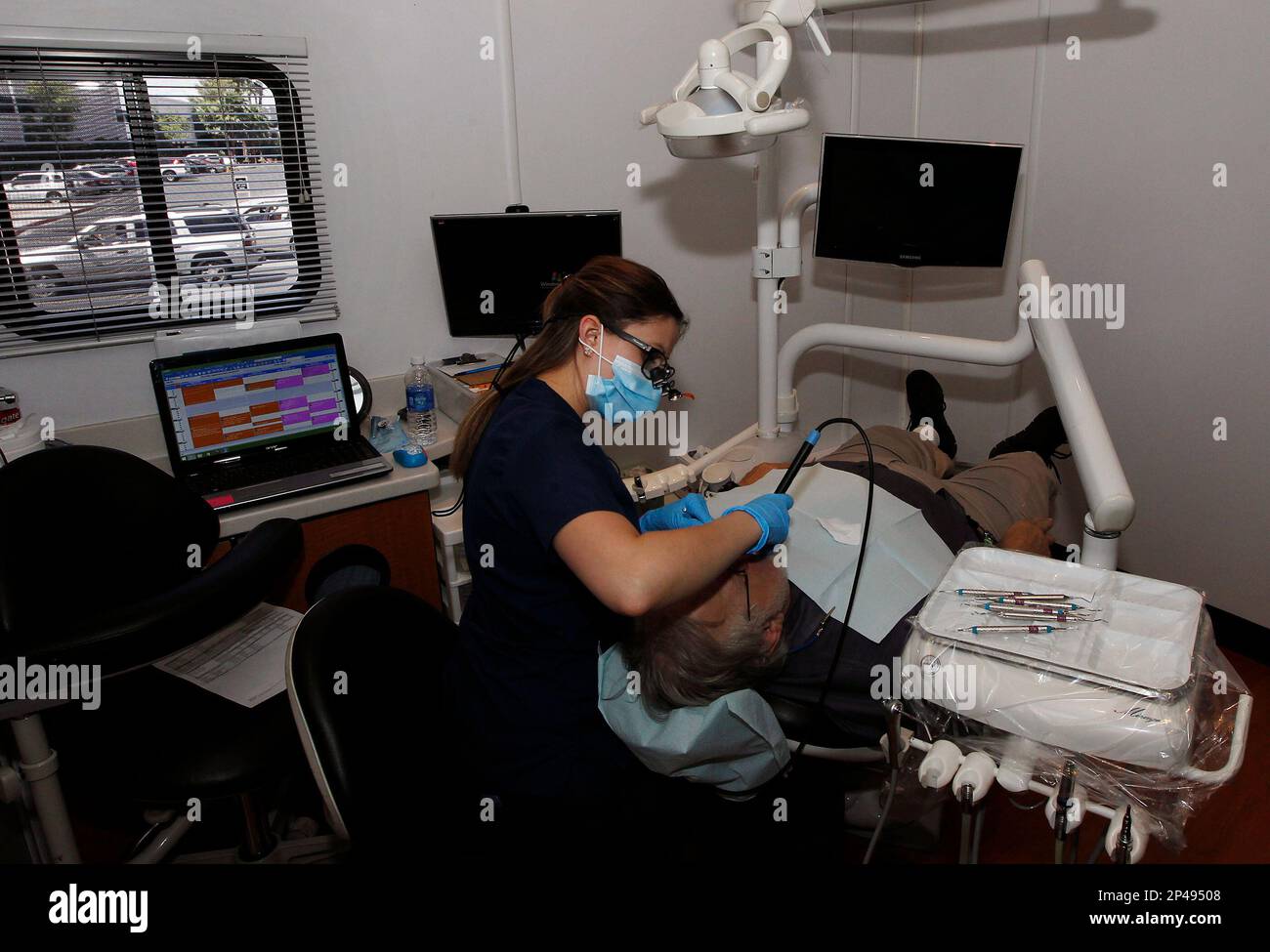 Dental Hygienist Lindsay Brock cleans Mirage employee Kevin Whitesides ...