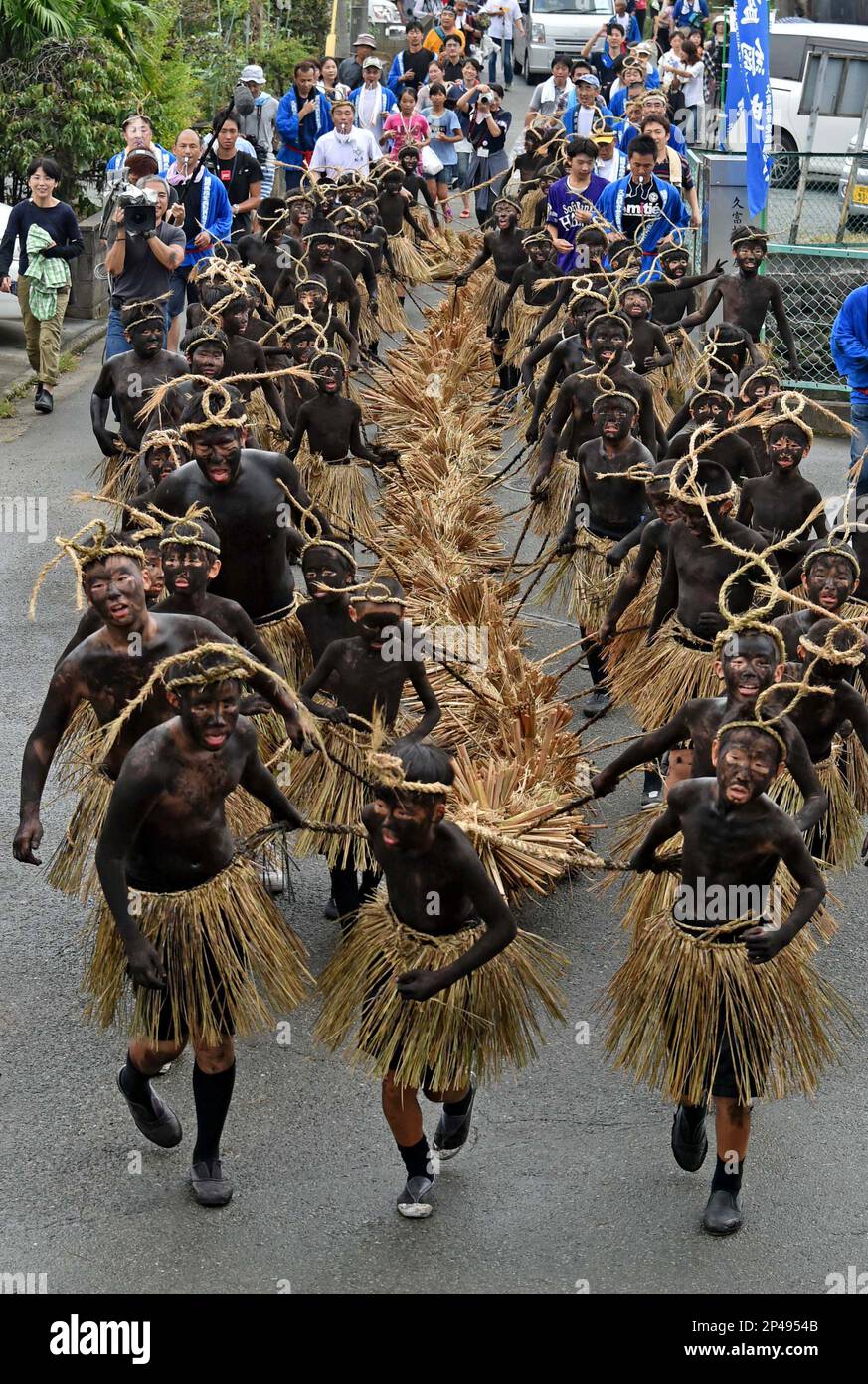 Children, wearing a straw-demons style, walk around the streets drawing ...