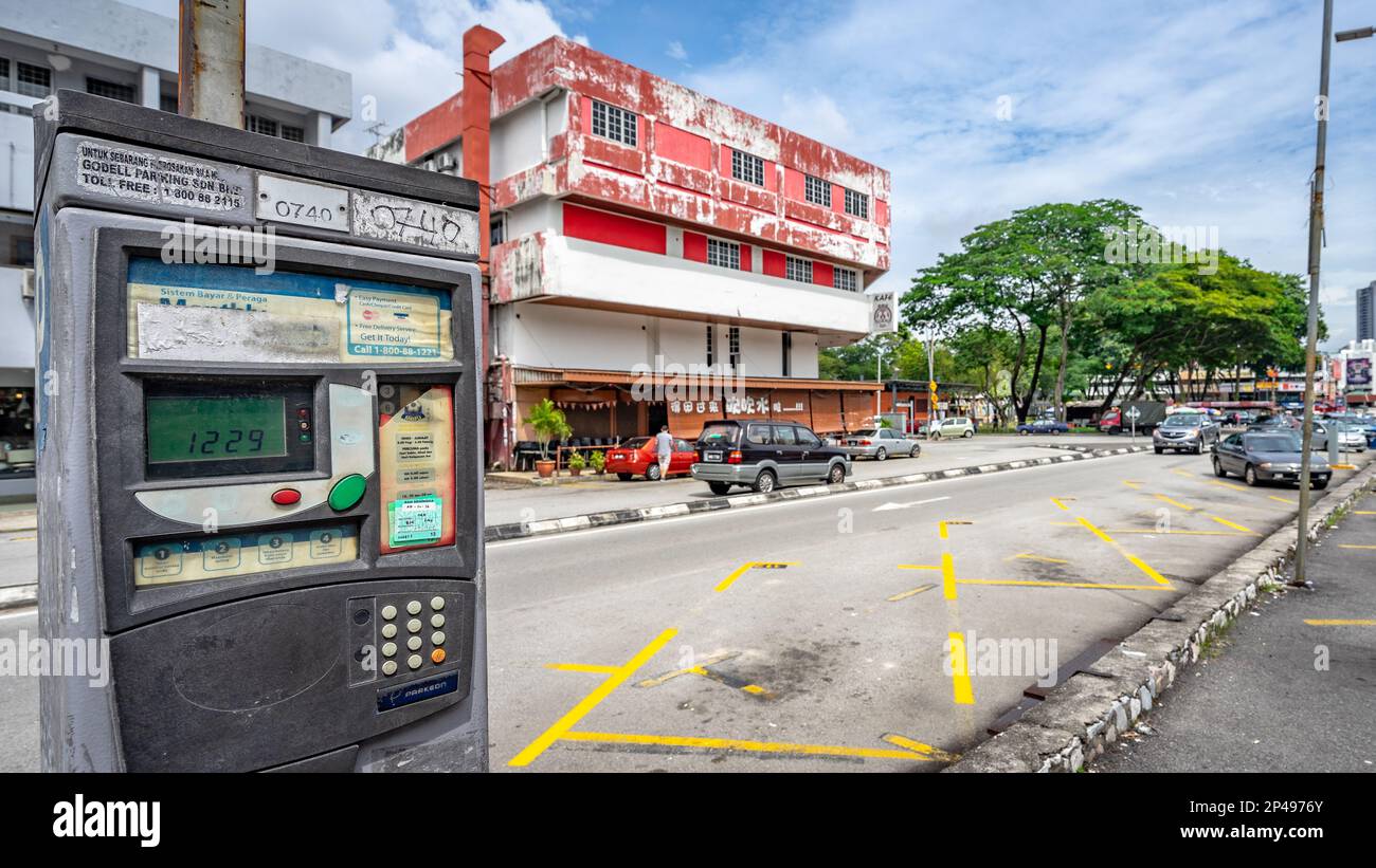 Kuala Lumpur, Malaysia - Street parking meter with a dilapidated ...