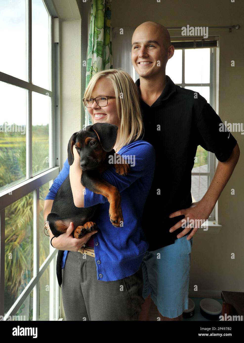Todd Blake, his wife Maja Blake and their new puppy Louie in their ...
