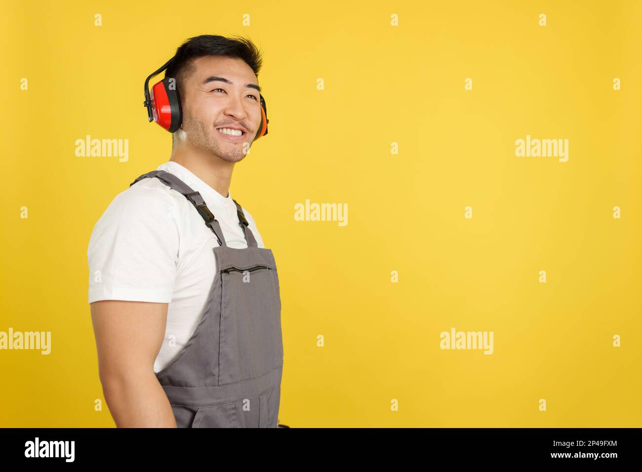 Chinese carpenter smiling distracted while looking up Stock Photo - Alamy