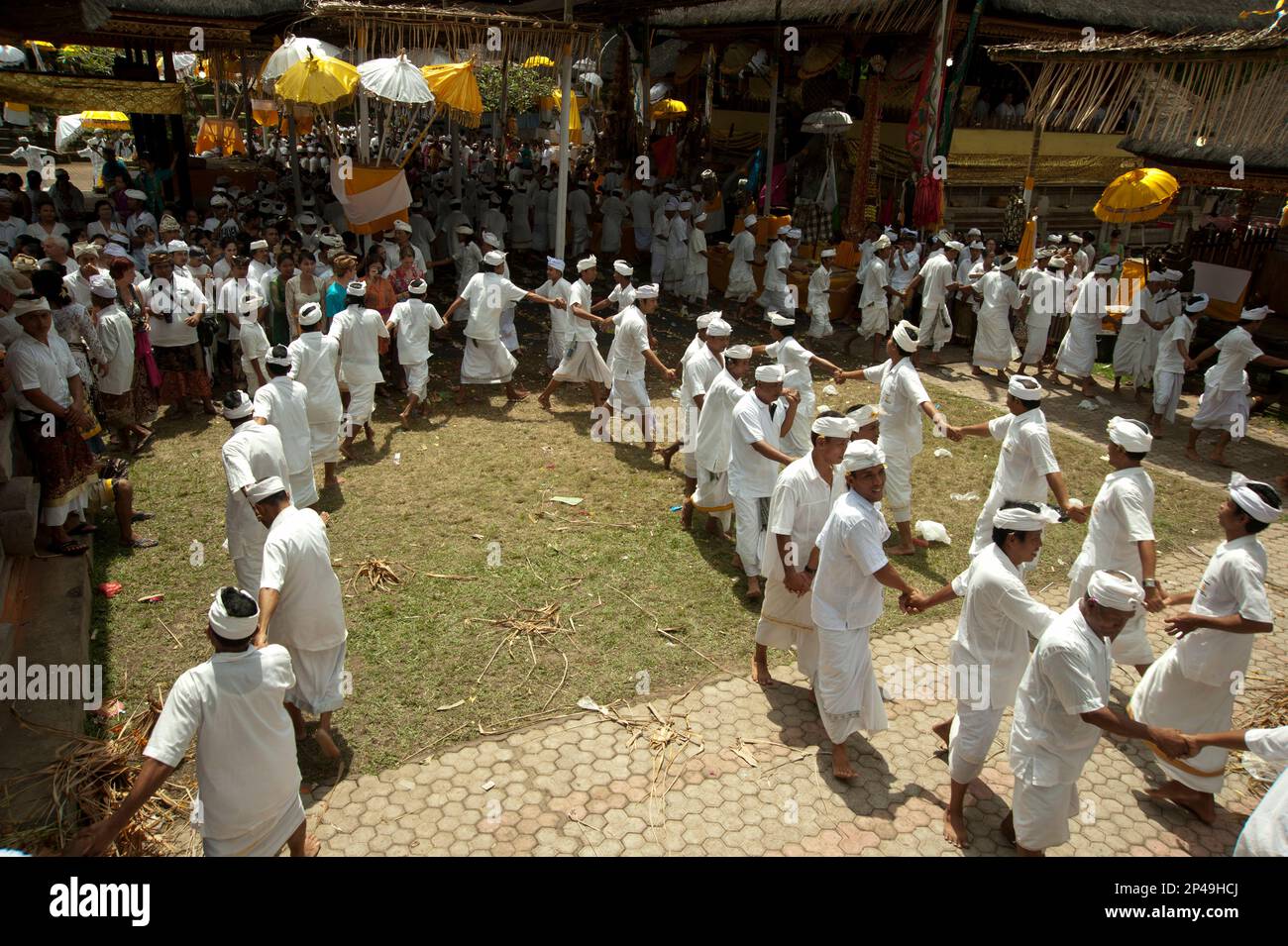 Men holding hands in procession preparing to fight during Siat Sampian ...